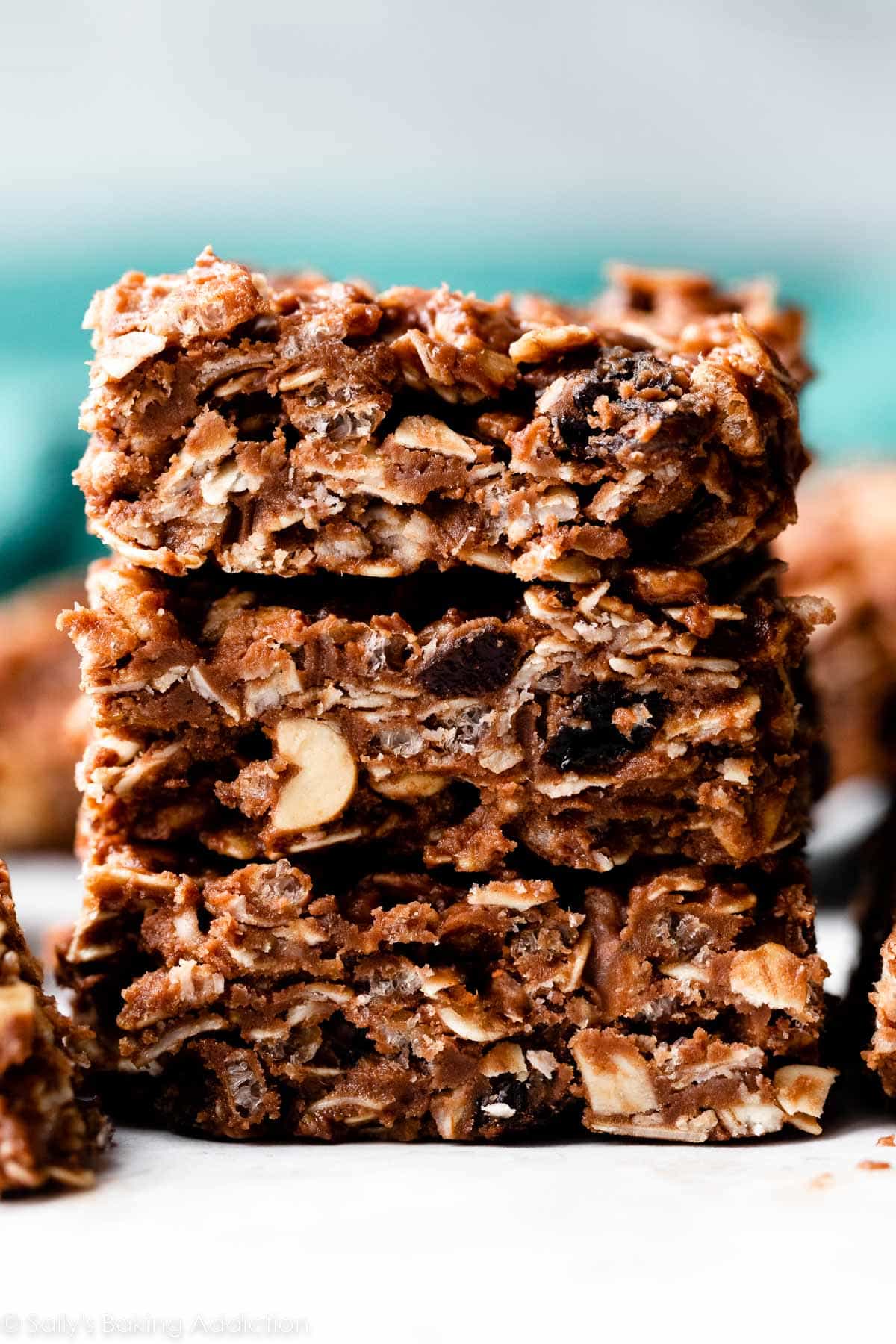 Stack Of 3 No bake Chocolate Oat Bars With Blue Linen In Background Stack Of 3 No bake Chocolate Oat Bars With Blue Linen In Background